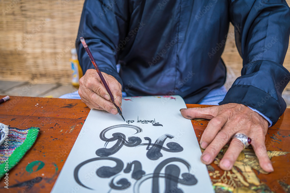 Vietnamese scholar wearing Ao Dai writes calligraphy. Calligraphy ...