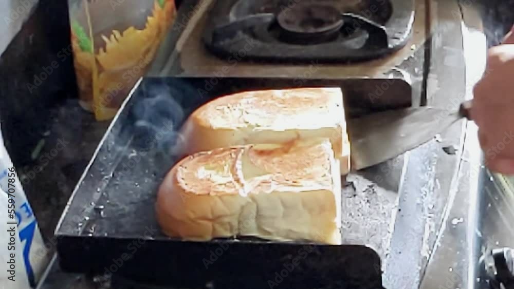 Slow motion. A toasting process of Roti Bakar. The toasting breads known as Roti Bakar is one of ...