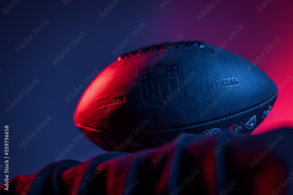 A football in epic light situation with the logo of the official brand ...