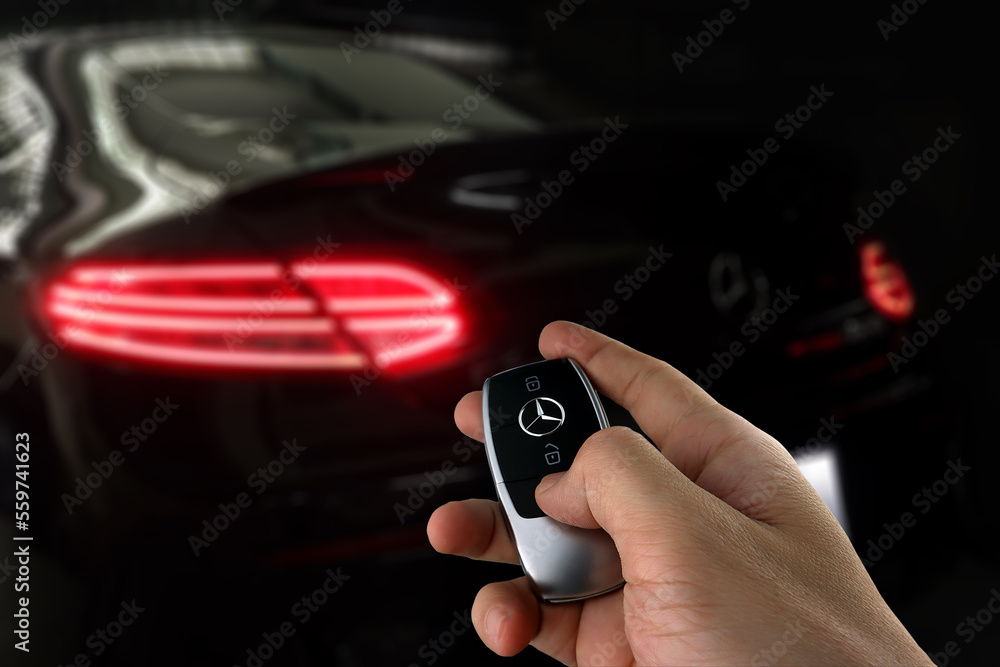 right hand holding car remote key to unlock and lock car of Benz c200 ...