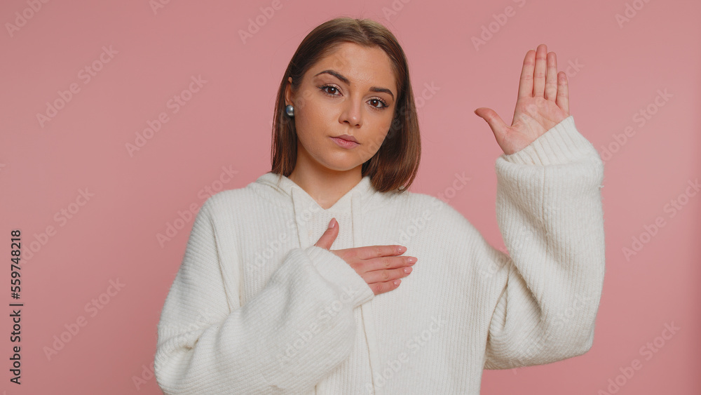 I swear to be honest. Sincere responsible young woman raising hand to ...