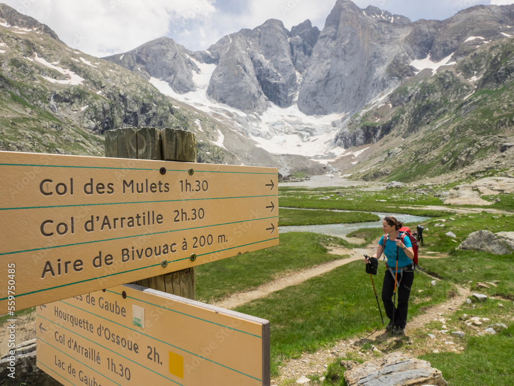 Woman hiking in the High Pyrenees in front of mount Vignemale ...