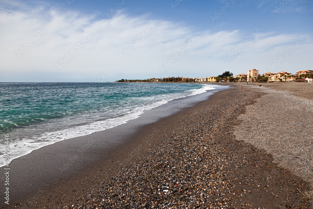 Spanish sea beach in the town of Motril with clear water and a small ...