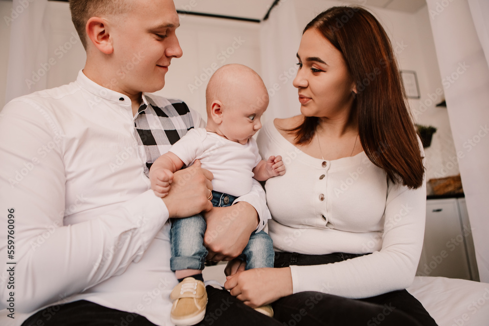 Little boy pop-eyed surprised cute child baby looking at mother breast ...