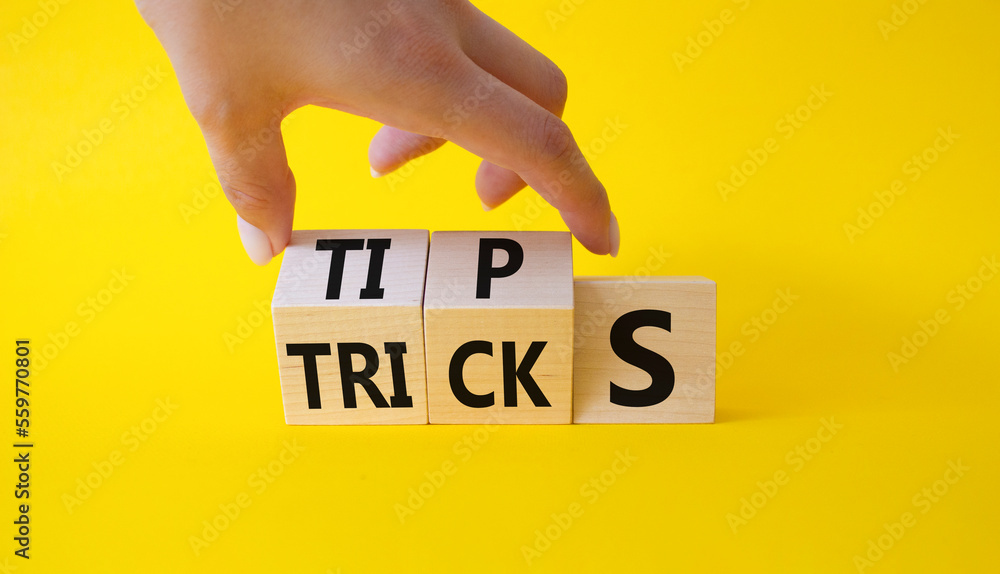 Tips and Tricks symbol. Businessman Hand turns cubes and changes word ...