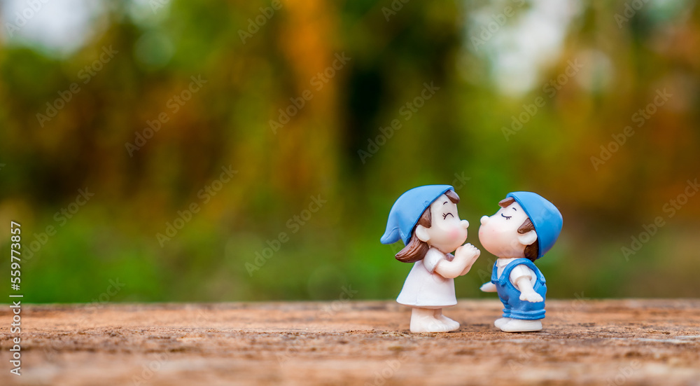 Doll miniature young lovers kissing. Model figure are dating blur ...