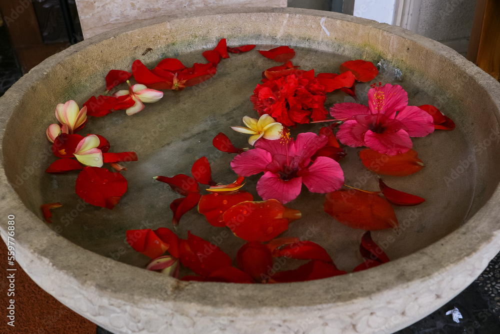 pot filled with water and hibiscus flowers (kembang sepatu), balinese ...
