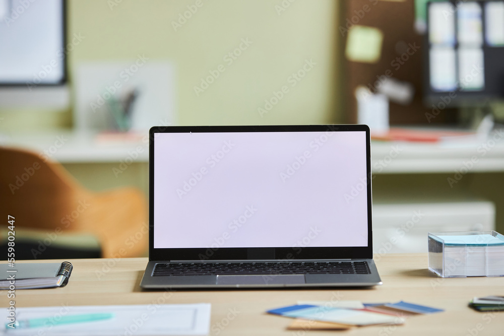 Background image of open laptop with white screen mock up on desk in ...