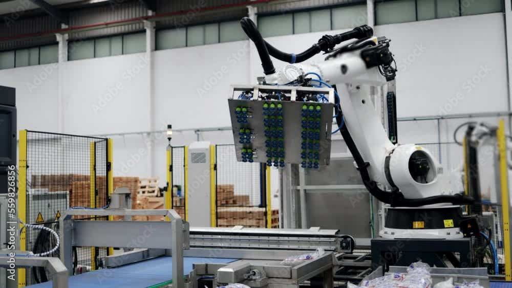 Robot arm working inside robotic automation facility - Industrial robot ...