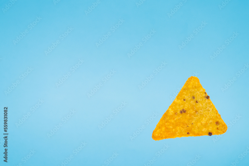nachos chips isolated on blue background. falling down doritos triangle ...