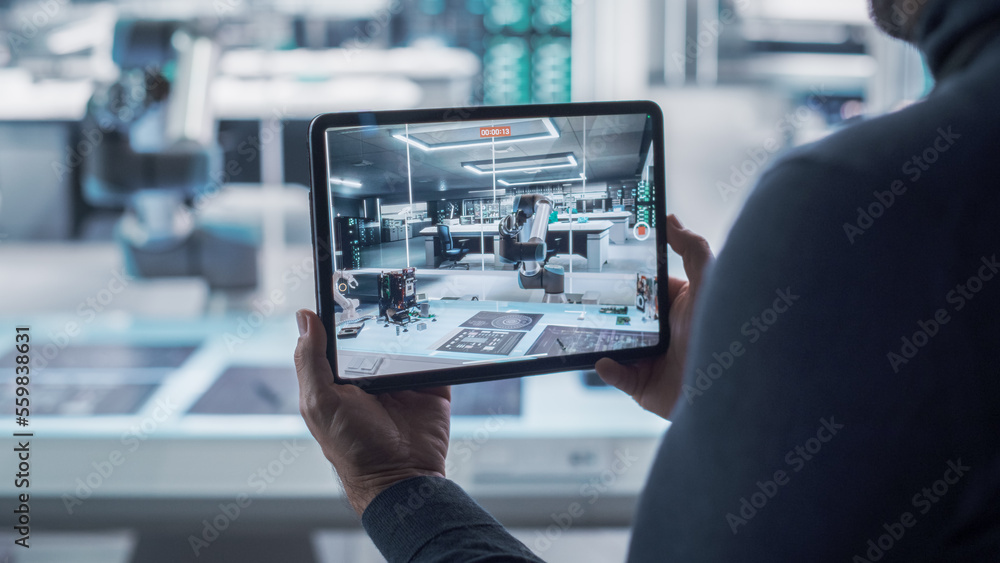 Over the Shoulder Shot of a Robotics Engineer Using a Tablet Computer ...