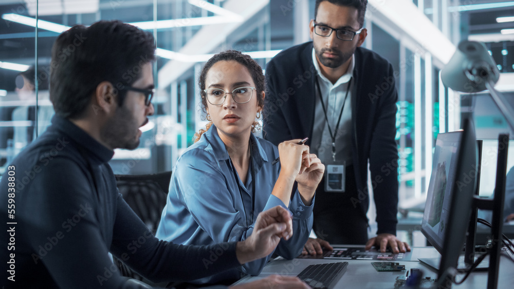 Team of Innovative Industrial Engineers Use Computer to Discuss a ...