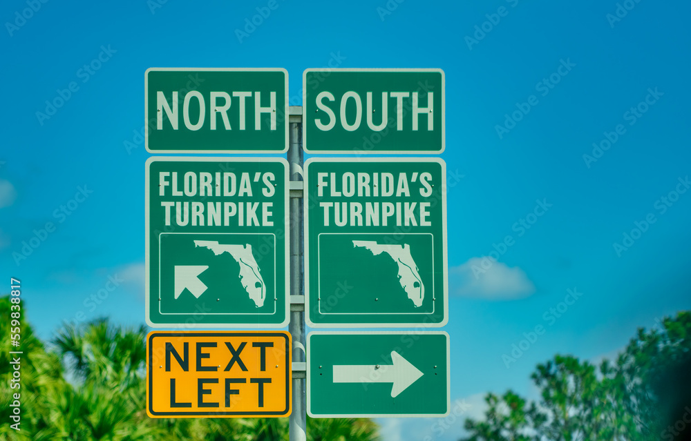 Photo Florida's turnpike road signage against palms and blue sky ...