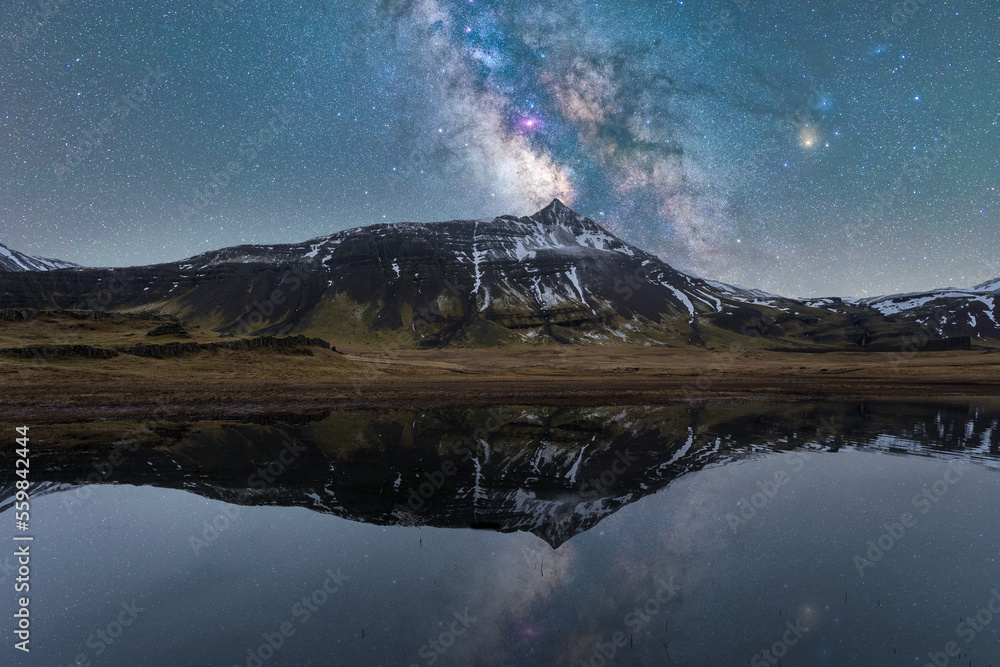 Majestic mountains of East Fjords in Iceland near lake under starry sky ...