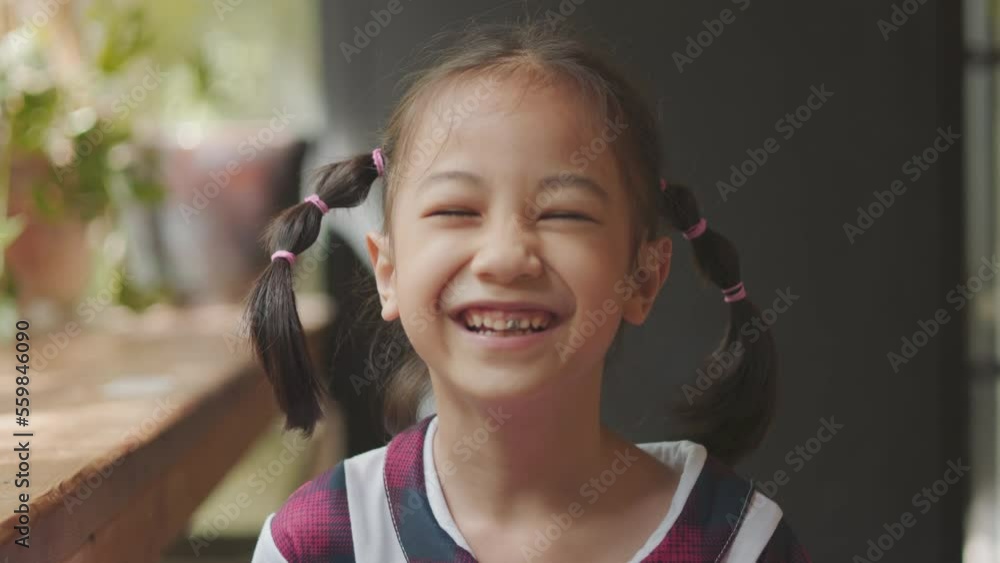 Close up face portrait of adorable asian kid girl who laughing in the ...