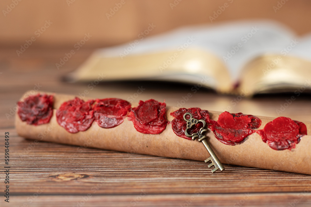 Ancient scroll with seven seals with old key on wooden table with holy ...