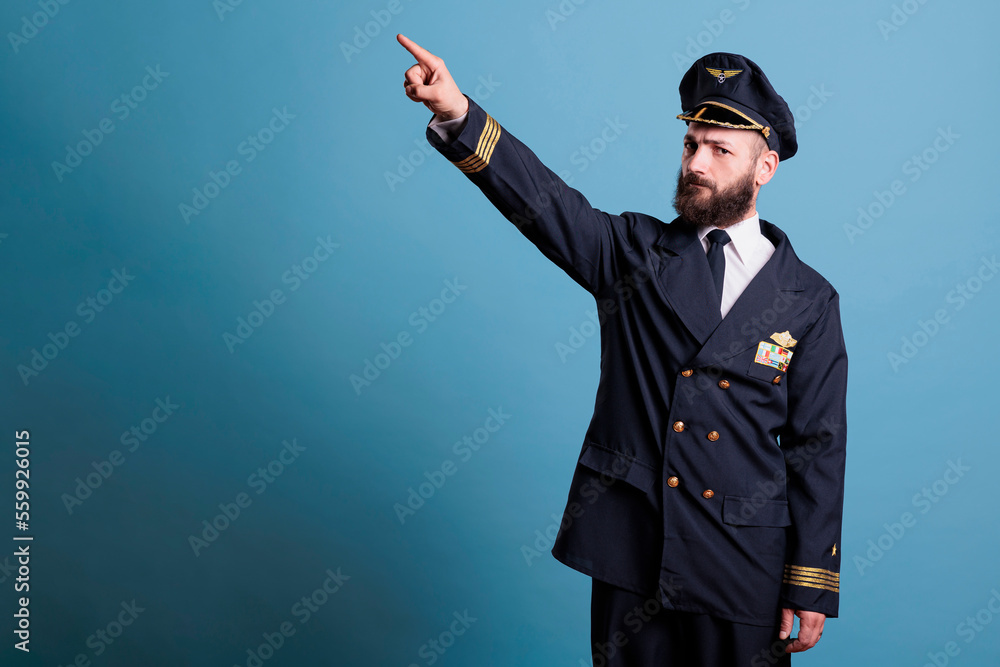 Airplane pilot pointing at sky with index finger, wearing professional ...