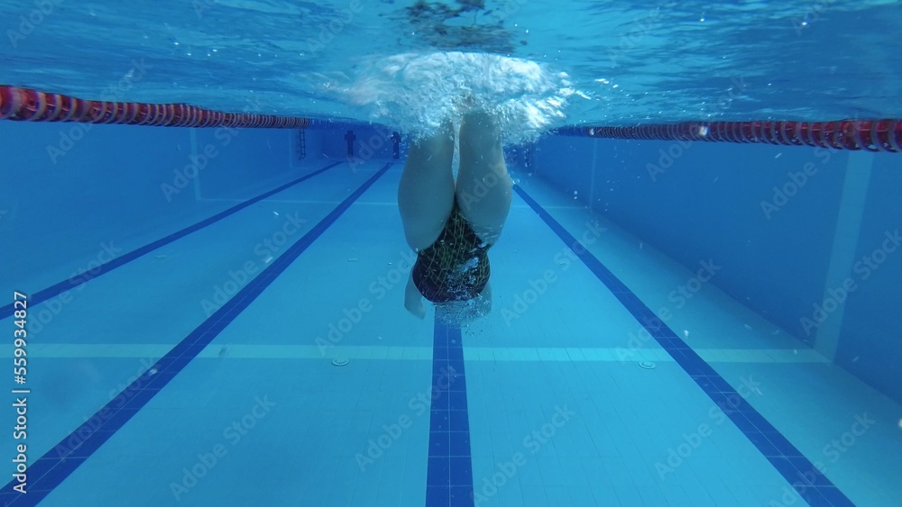 sportswoman swimmer in a tracksuit, in diving goggles, in a swimming ...