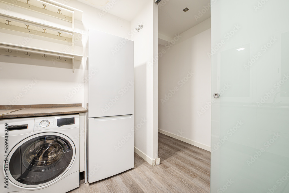 Corner of a kitchen with a tempered glass door, brownstone worktop and ...