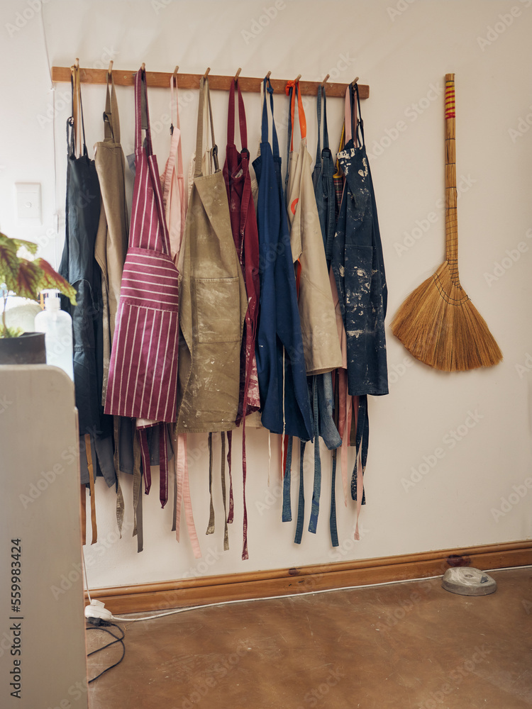 Foto de Clothes rack, apron and pottery with a broom in an empty ...