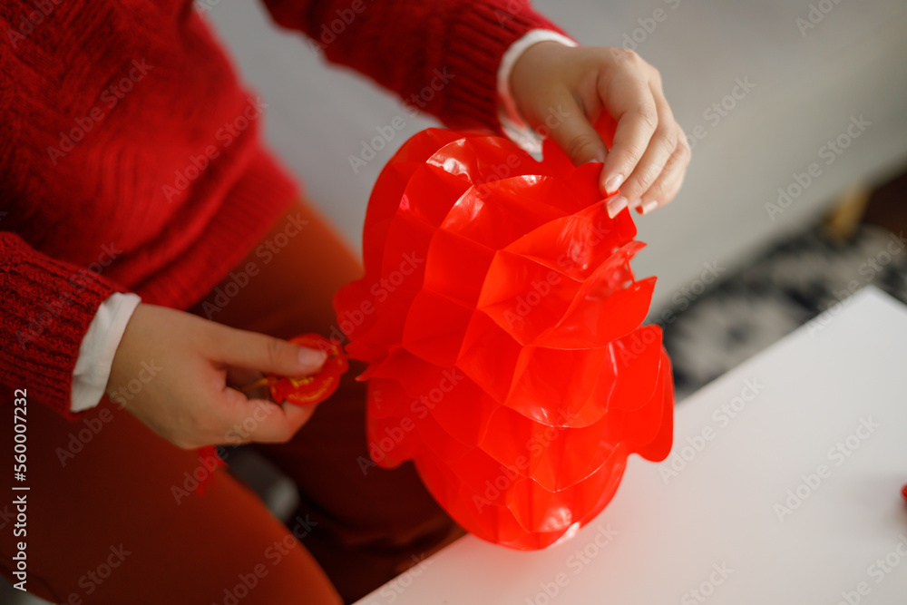 Asian woman wearing red clothes making paper craft red Chinese new year ...