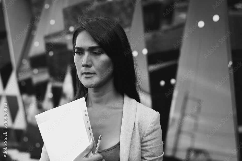 Asian business woman portrait with concerned look holding files folder ...
