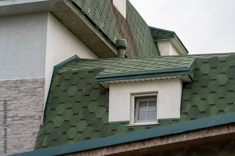 Green bitumen roof of house under construction with smokestack and ...