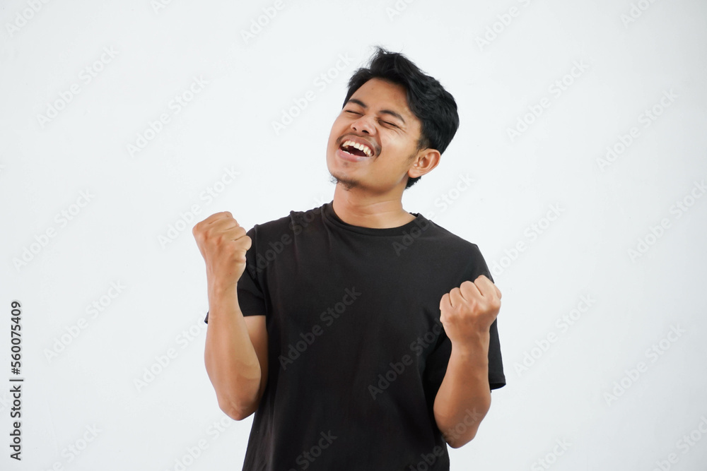 Confident cheerful handsome asian man lifting hands up wearing black t ...