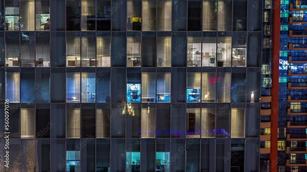 Night aerial view of office building glass window facade with ...