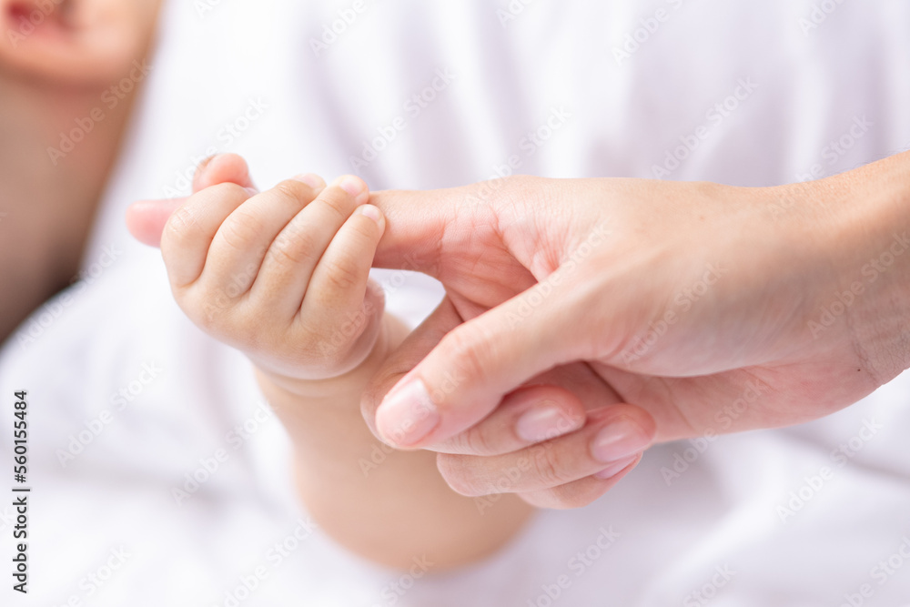 baby's hand put on mom's hand. Stock Photo | Adobe Stock