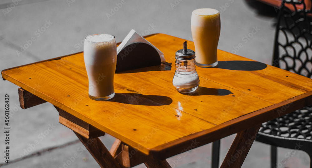 Mesa bacía en una vereda con dos basos de licuado Stock Photo | Adobe Stock
