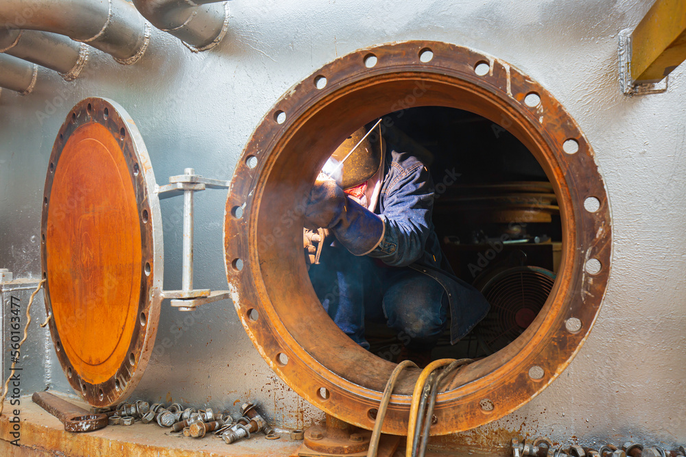 Welding male worker metal is part of machinery plate tank beam pipe ...