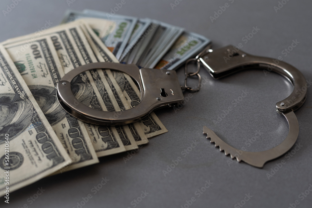 The handcuffs are on hundred-dollar bills. Power and bribery. Criminal ...