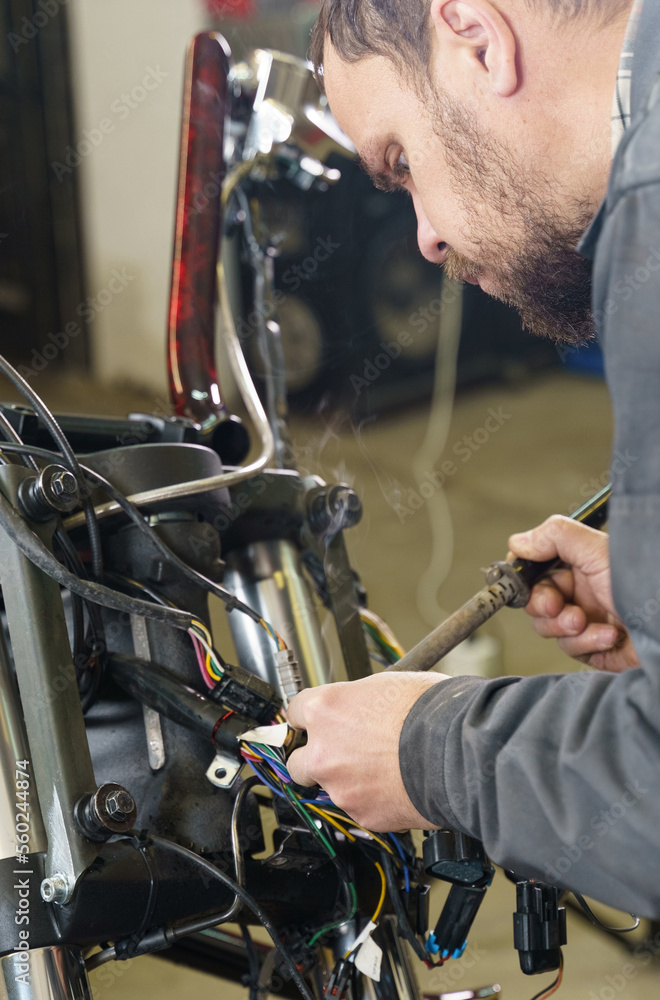 Electrician soldering electrical wires to electrical equipment. Stock ...