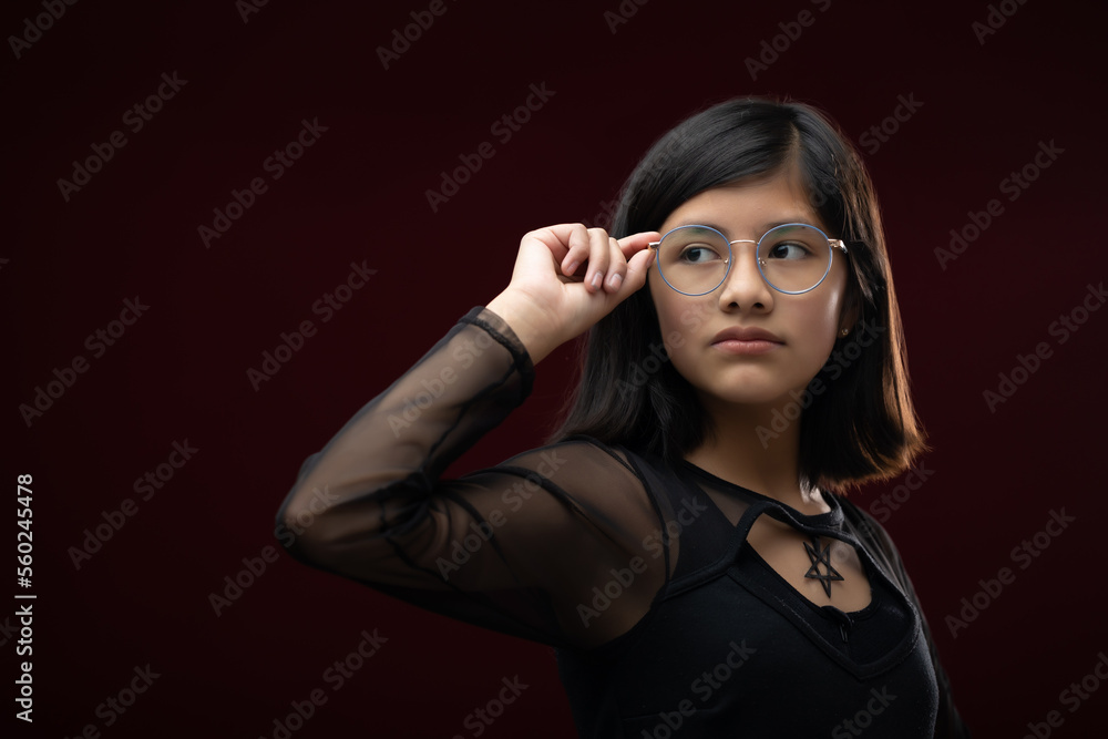 12 year old Mexican girl portrait isolated on red background wearing ...