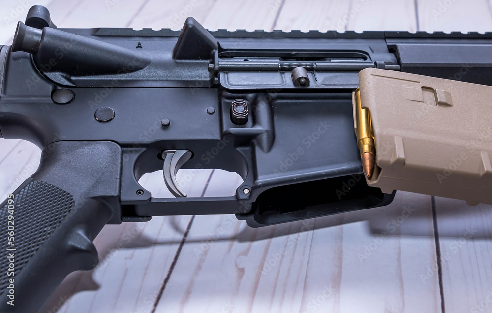 An AR15 rifle chambered in 223 caliber with a loaded magazine next to ...