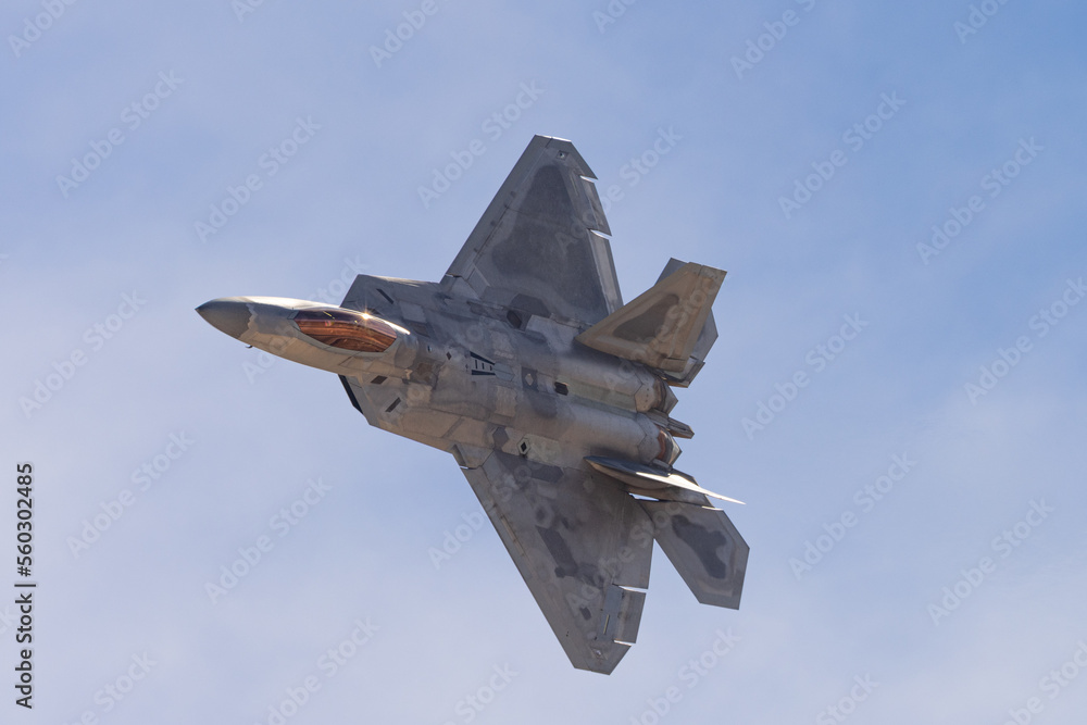 F-22 Raptor in a turn in beautiful light , with afterburners on Stock ...