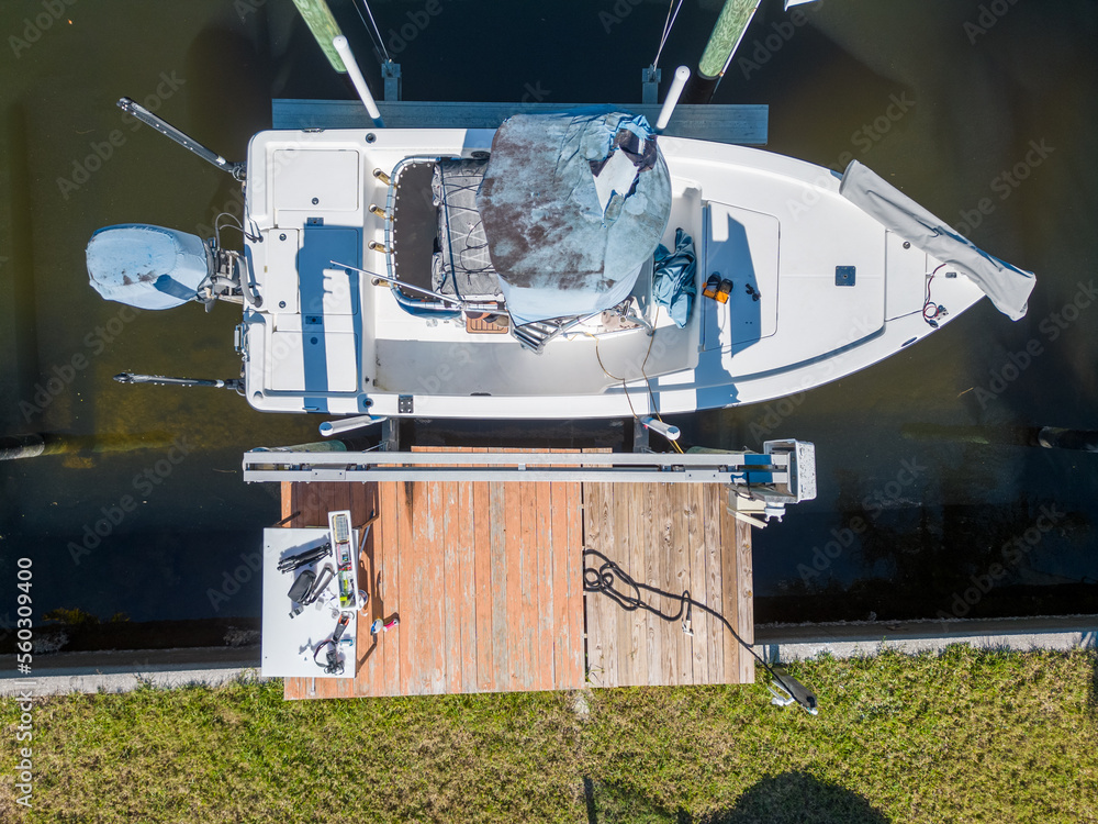 Foto de Top down of 15 foot ocean sea boat on boat lift with tower next ...