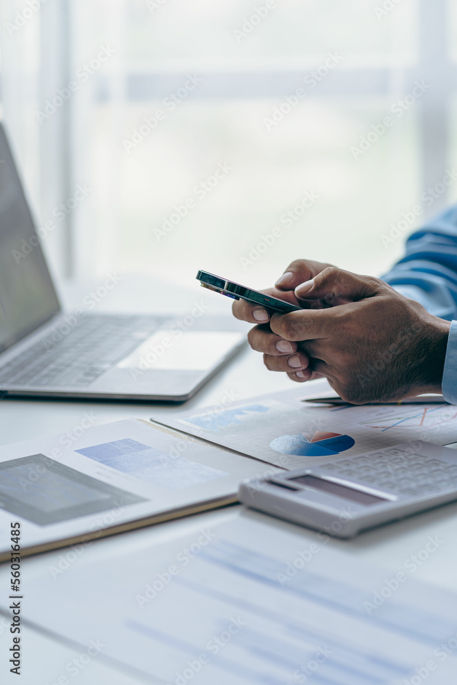 Businessman holding pen pointing to bar chart on company finance ...