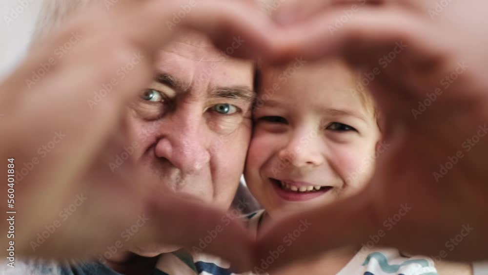 Grandfather and Grandson Making a Heart Shape Hand Gesture Together ...