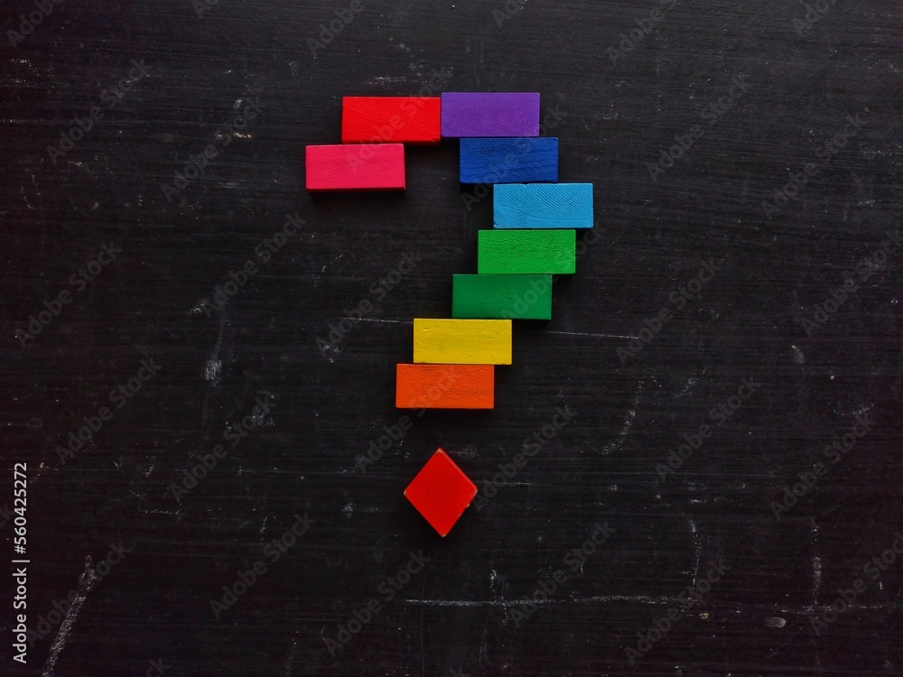 Forming bigger colorful question mark. question mark on table ...