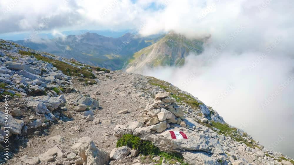 Rock mountains peak covered with clouds and fog, painted directional ...