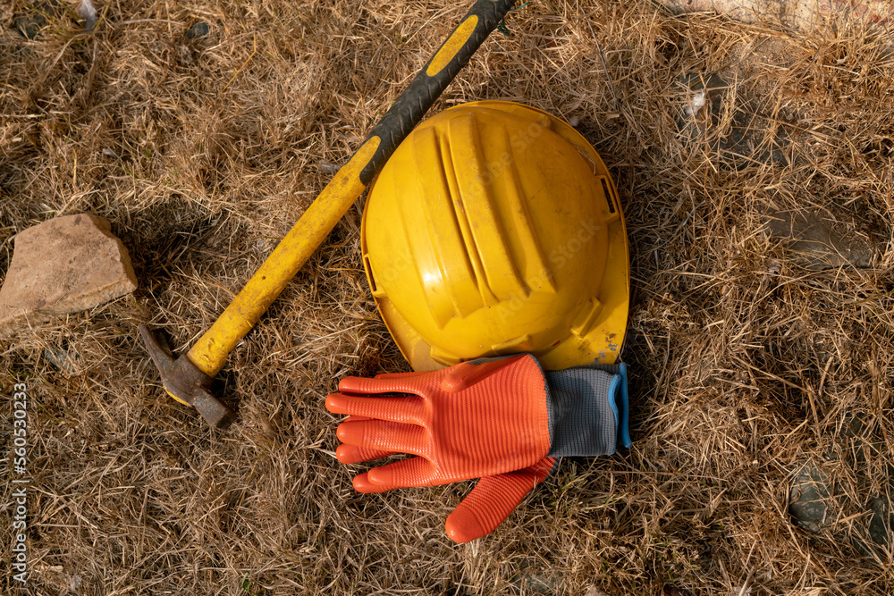 work on construction sites, individual protection of helmet, hammer and ...