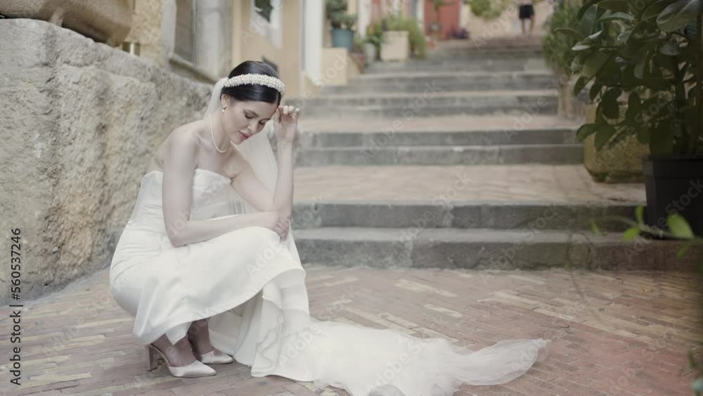 The bride in a white dress and a transparent veil. Action. Beautiful ...