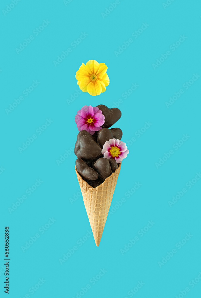 Ice cream cone with honey chocolate hearts cookies and colorful flowers ...