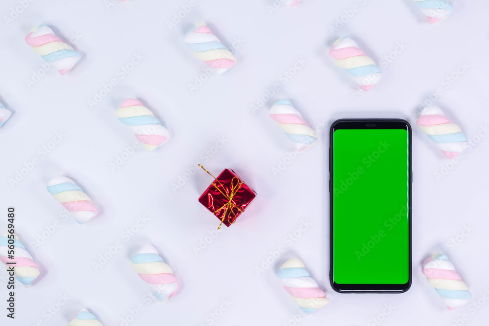 Phone mobile telephone with a vertical green screen. Red Christmas ...