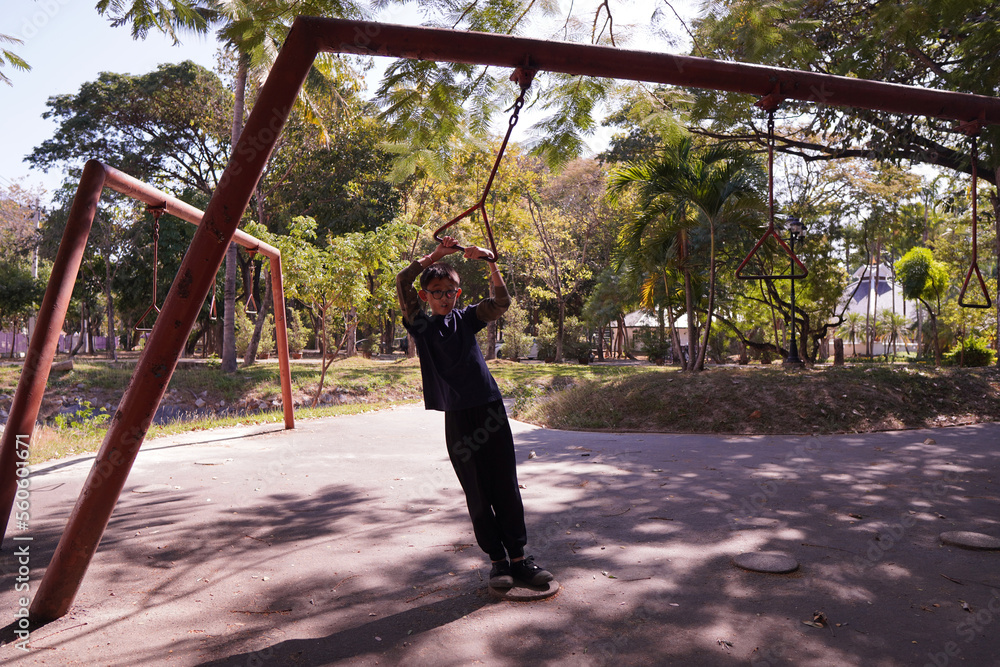 An image shows a young boy demonstrating a circular swing exercise ...