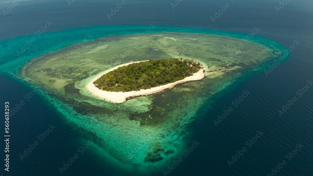 Small tropical island on an atoll with beautiful sandy beach surrounded ...