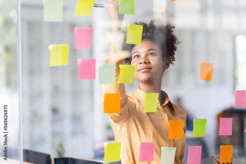 Young Serious african american Creative team use post it notes to share ...