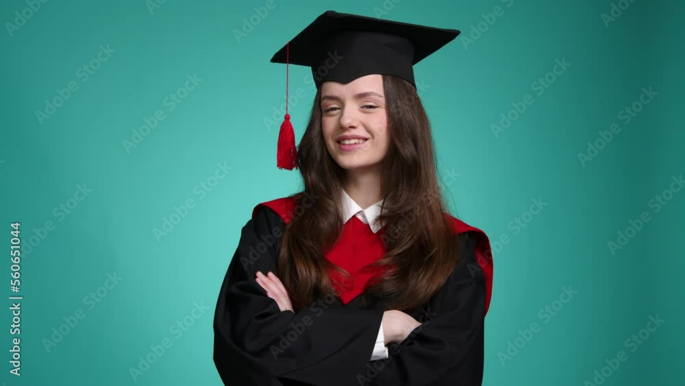Close-up view of cute, young woman in her 20s wearing black gown ...